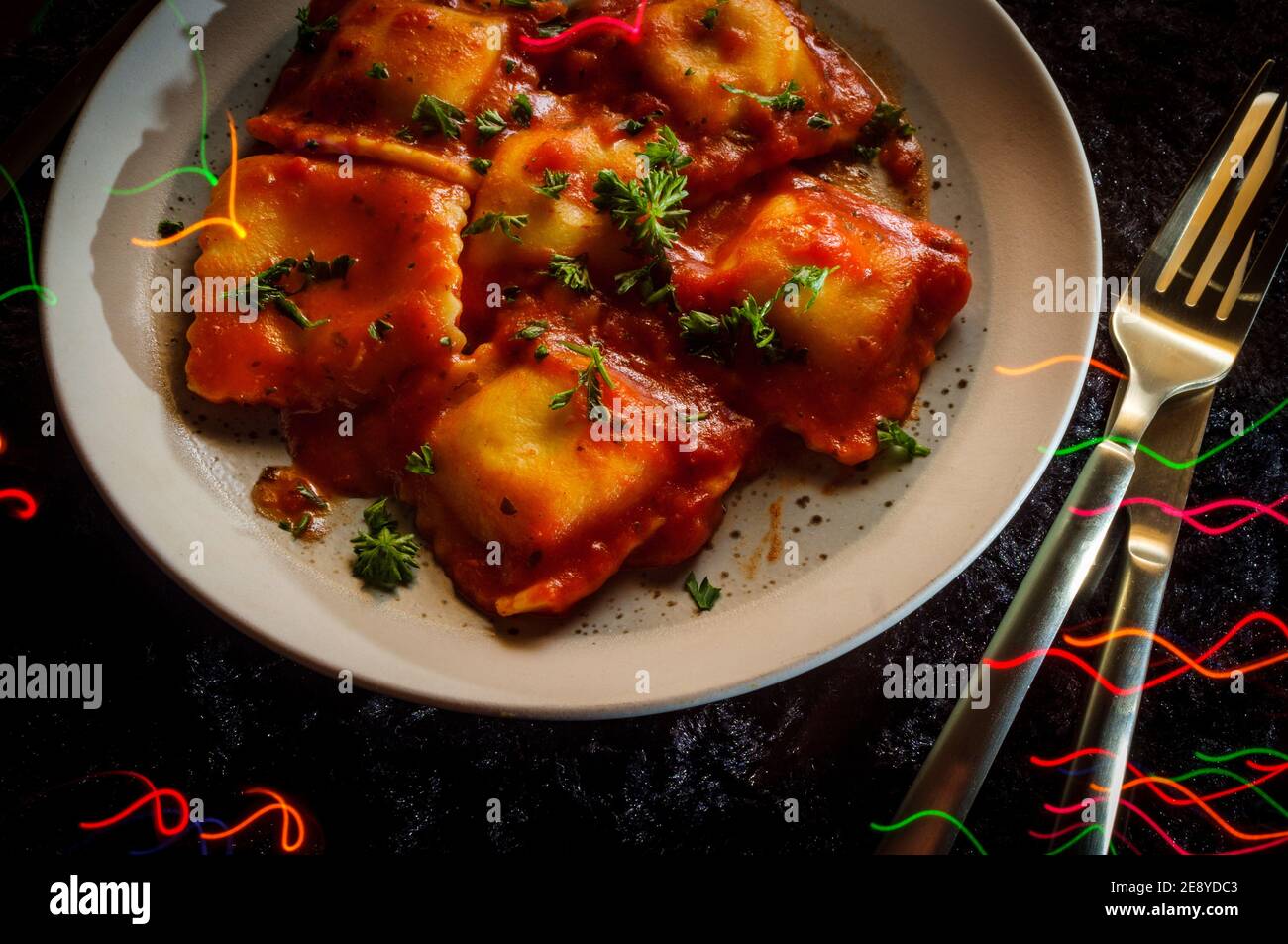 Italian ravioli with tomato sauce exciting celebration with neon light ...