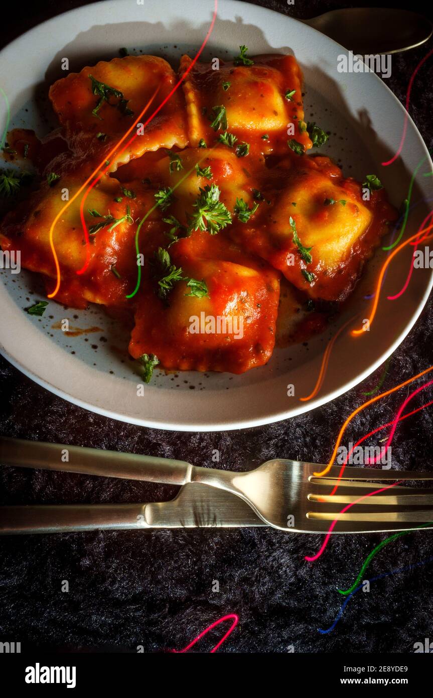Italian ravioli with tomato sauce exciting celebration with neon light ...