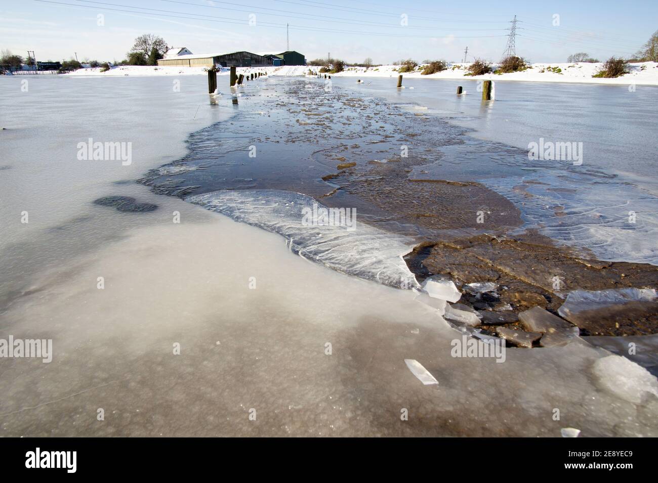 Frozen over farm road example Stock Photo - Alamy