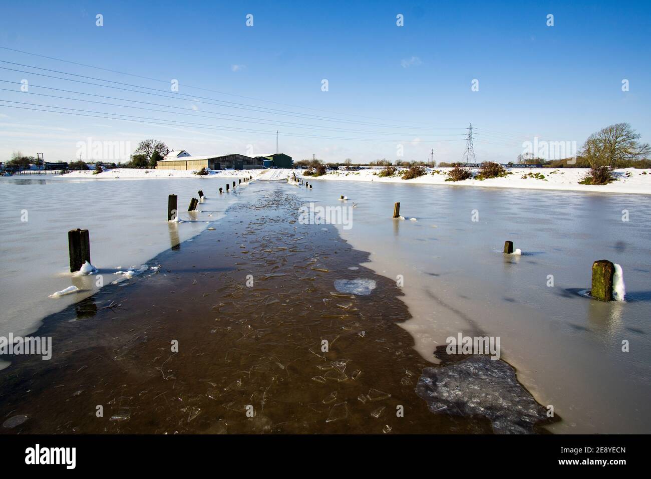Frozen over farm road example Stock Photo - Alamy