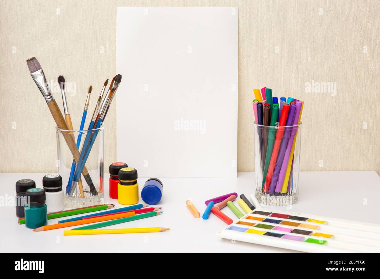 White table with colorful drawing supplies. Mock up Stock Photo - Alamy