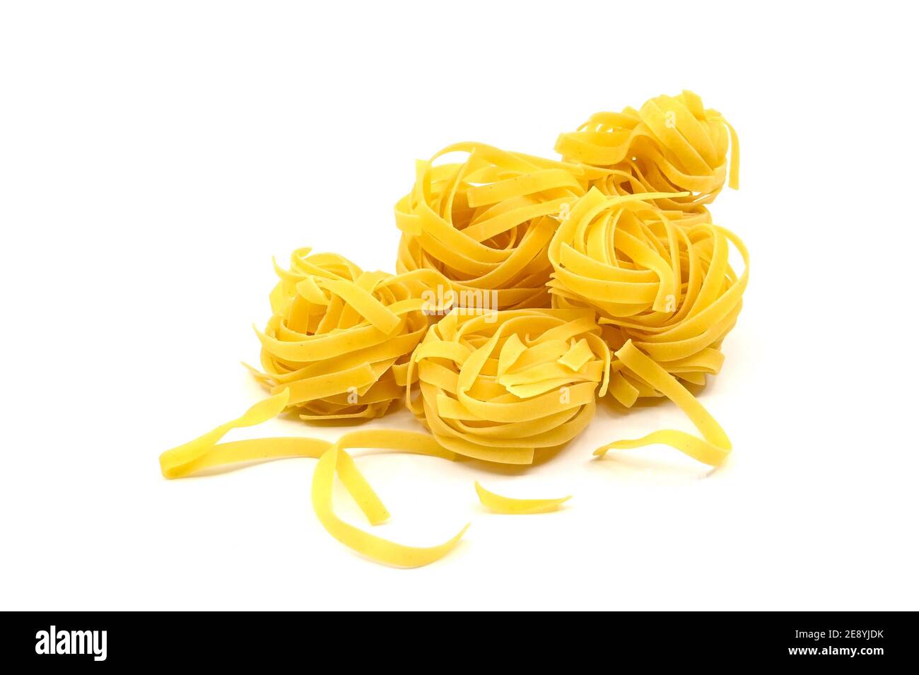 Spiral nests of dried tagliatelle past. No people. Copy space Stock ...