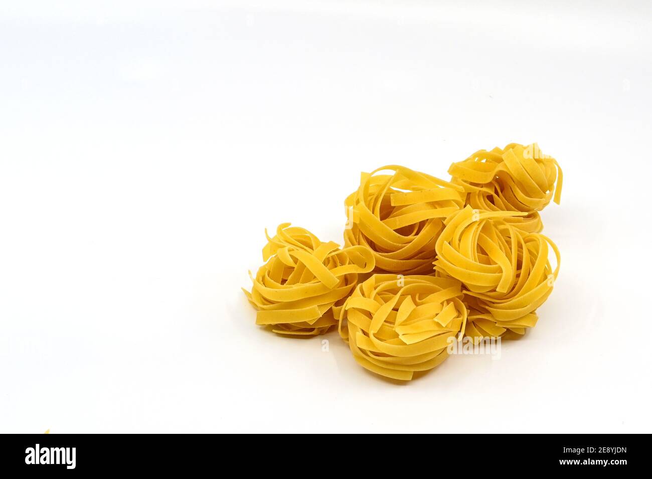 Spiral nests of dried tagliatelle past. No people. Copy space Stock ...