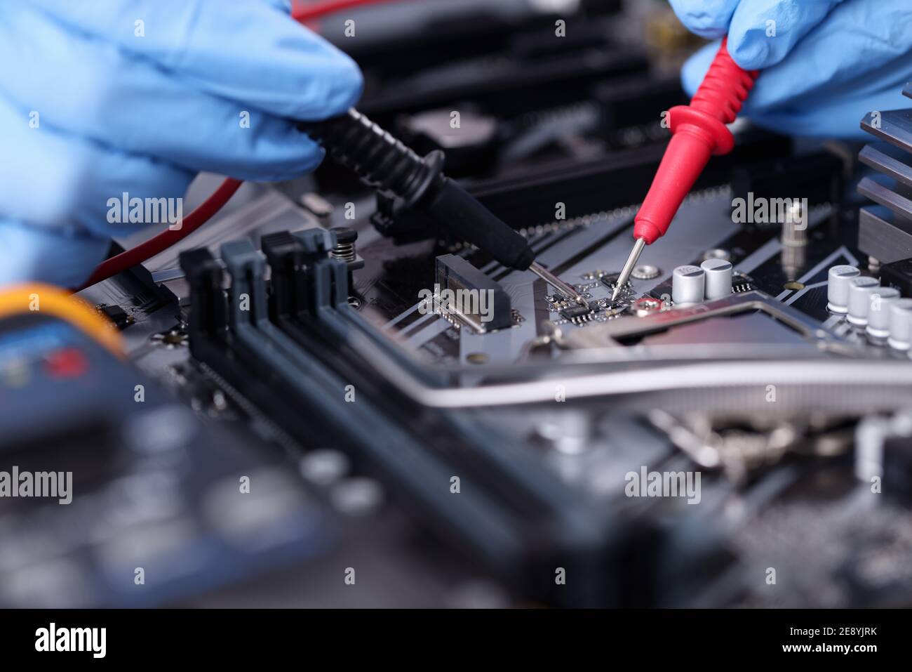 Hands in rubber gloves repairing computer closeup Stock Photo - Alamy