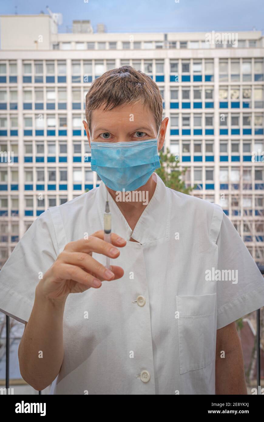Paris, France - 31 01 2021: Masked nurse dressed in a white lab coat ...