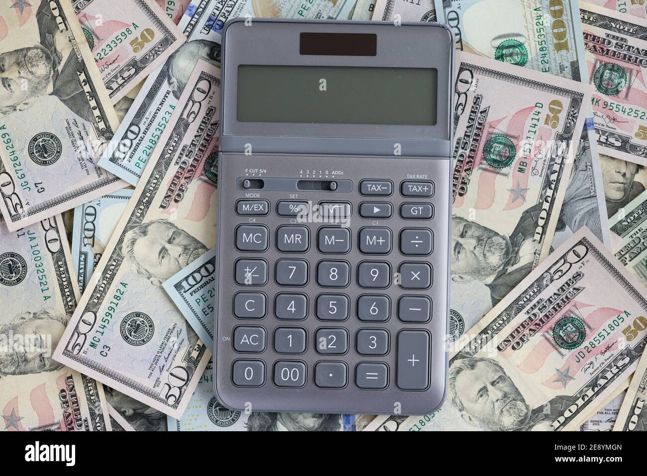 Calculator lying on set of American dollar bills closeup Stock Photo ...