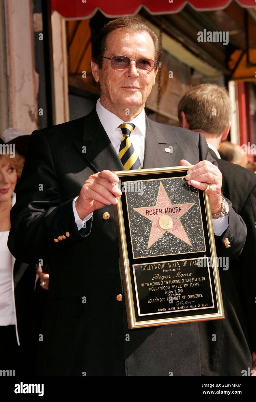 File Photo - Sir Roger Moore is honored with the 2,350th Star on The ...