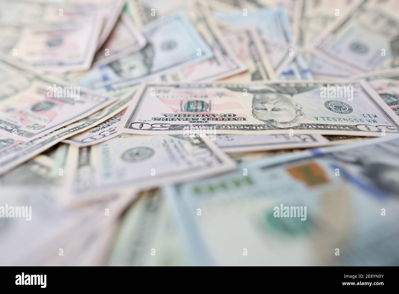 Lot of american dollar bills lying on table closeup Stock Photo - Alamy