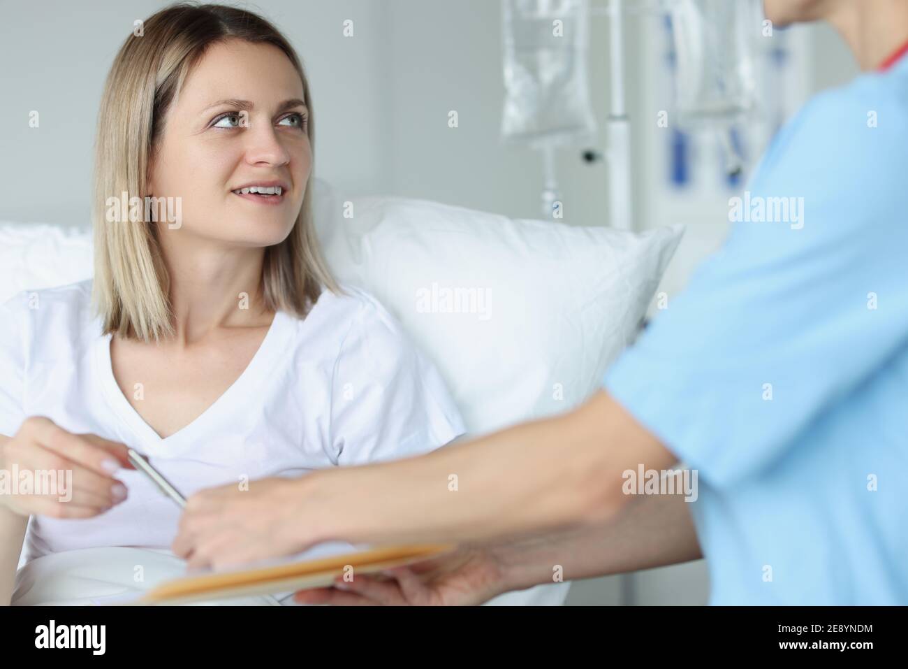 Doctor giving woman patient ballpoint pen in clinic Stock Photo - Alamy