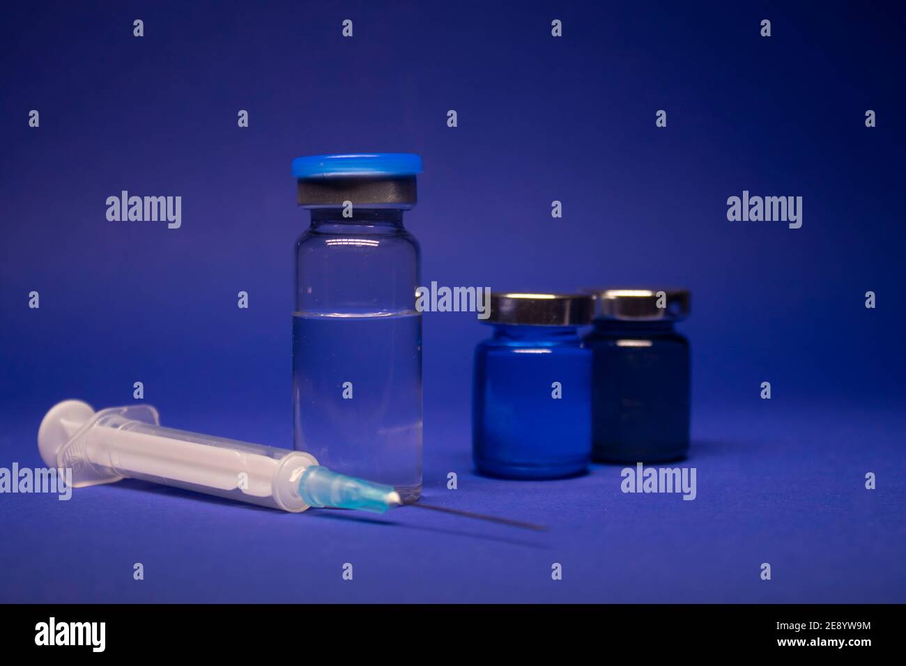 three transparent Vaccine bottle phial with no label, medical syringe ...