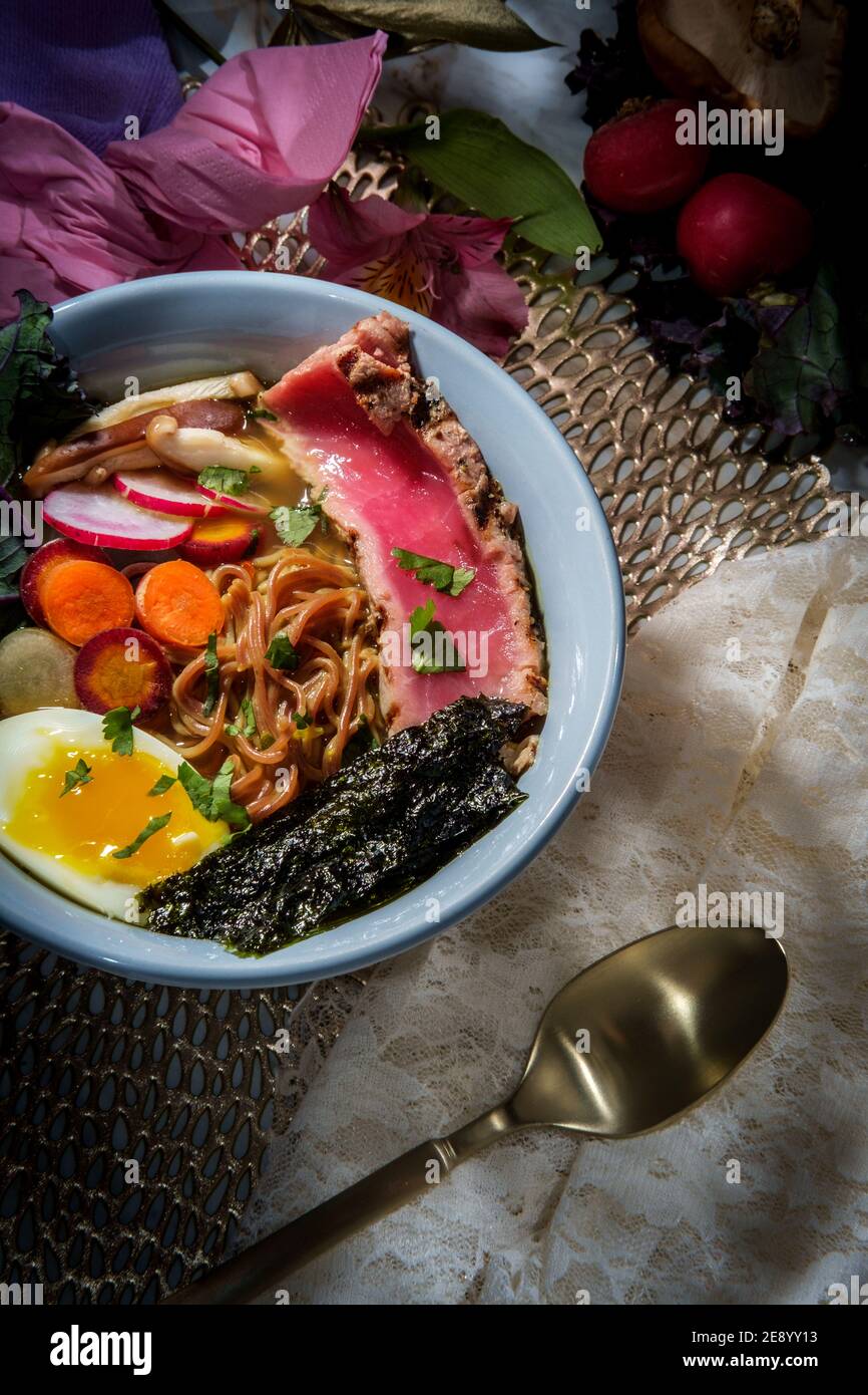 Seared pink ahi tuna ramen garnished with soft boiled egg seaweed ...