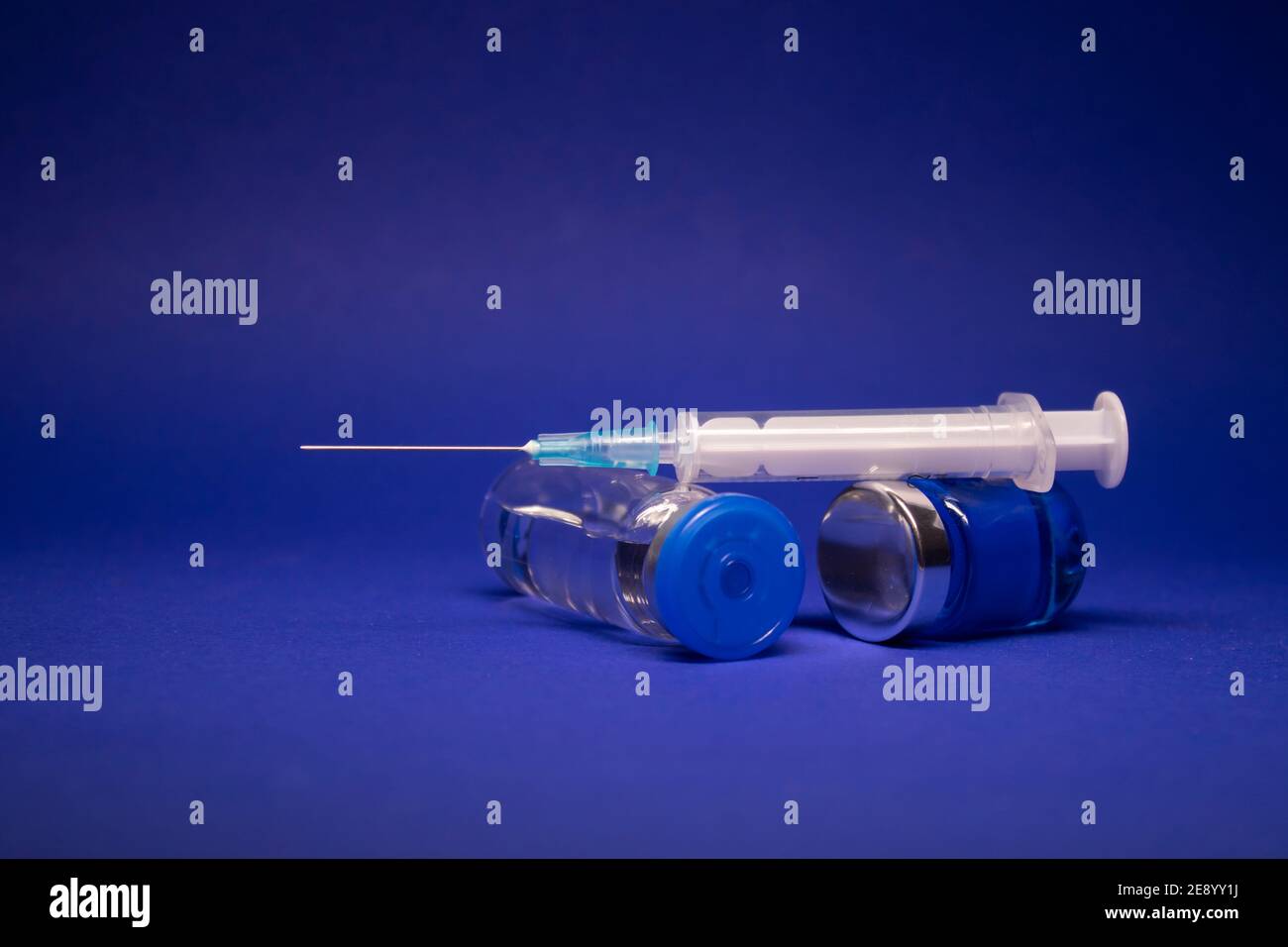 two transparent Vaccine bottle phial with no label, medical syringe ...