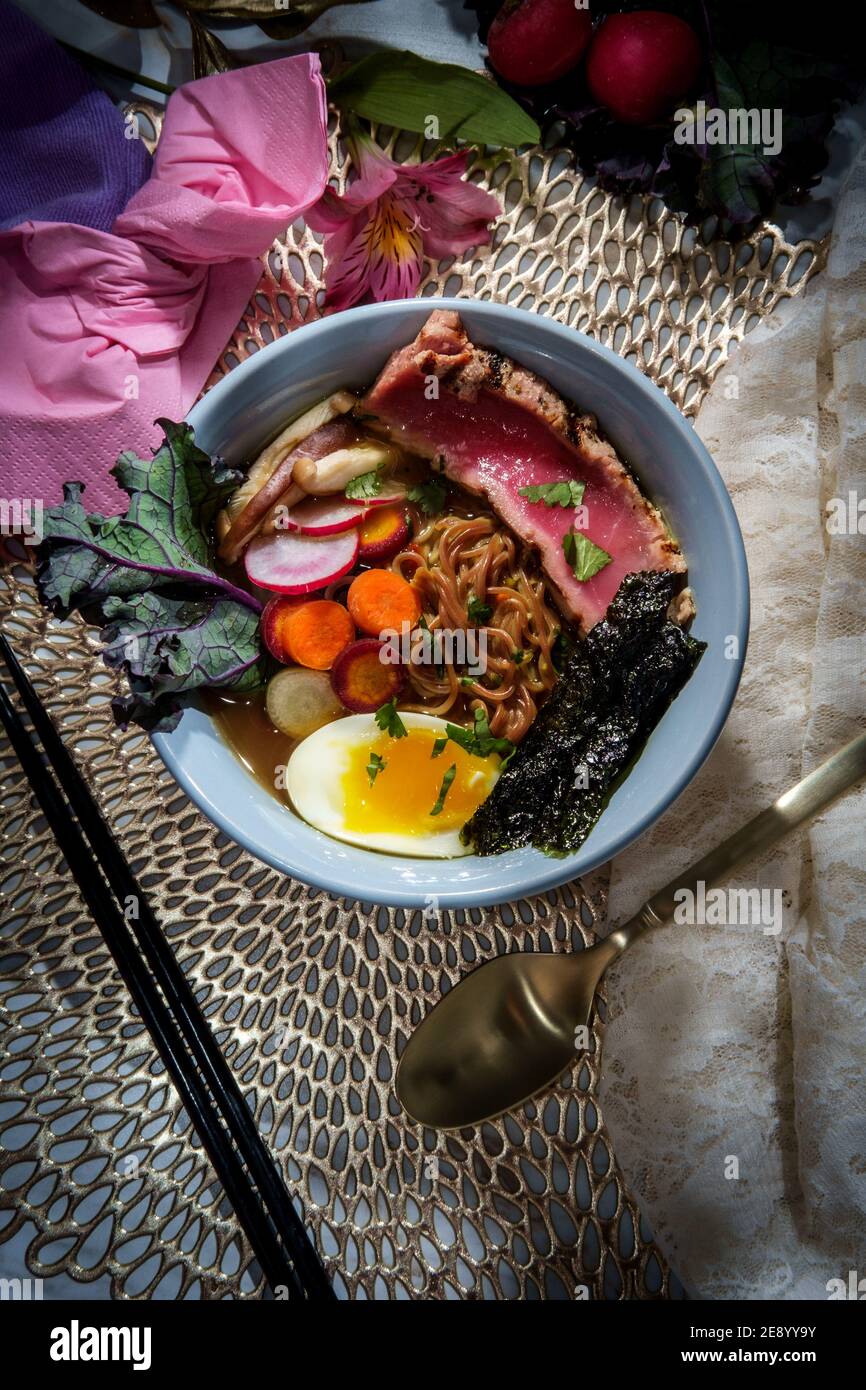 Seared pink ahi tuna ramen garnished with soft boiled egg seaweed ...