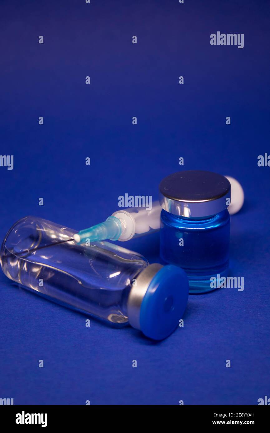 two transparent Vaccine bottle phial with no label, medical syringe ...