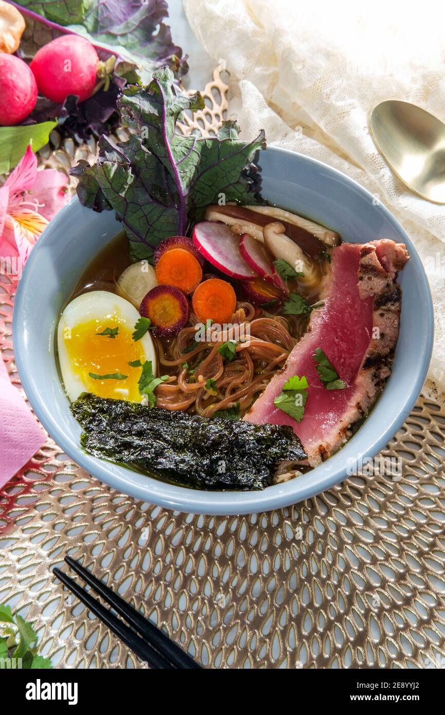 Seared pink ahi tuna ramen garnished with soft boiled egg seaweed ...