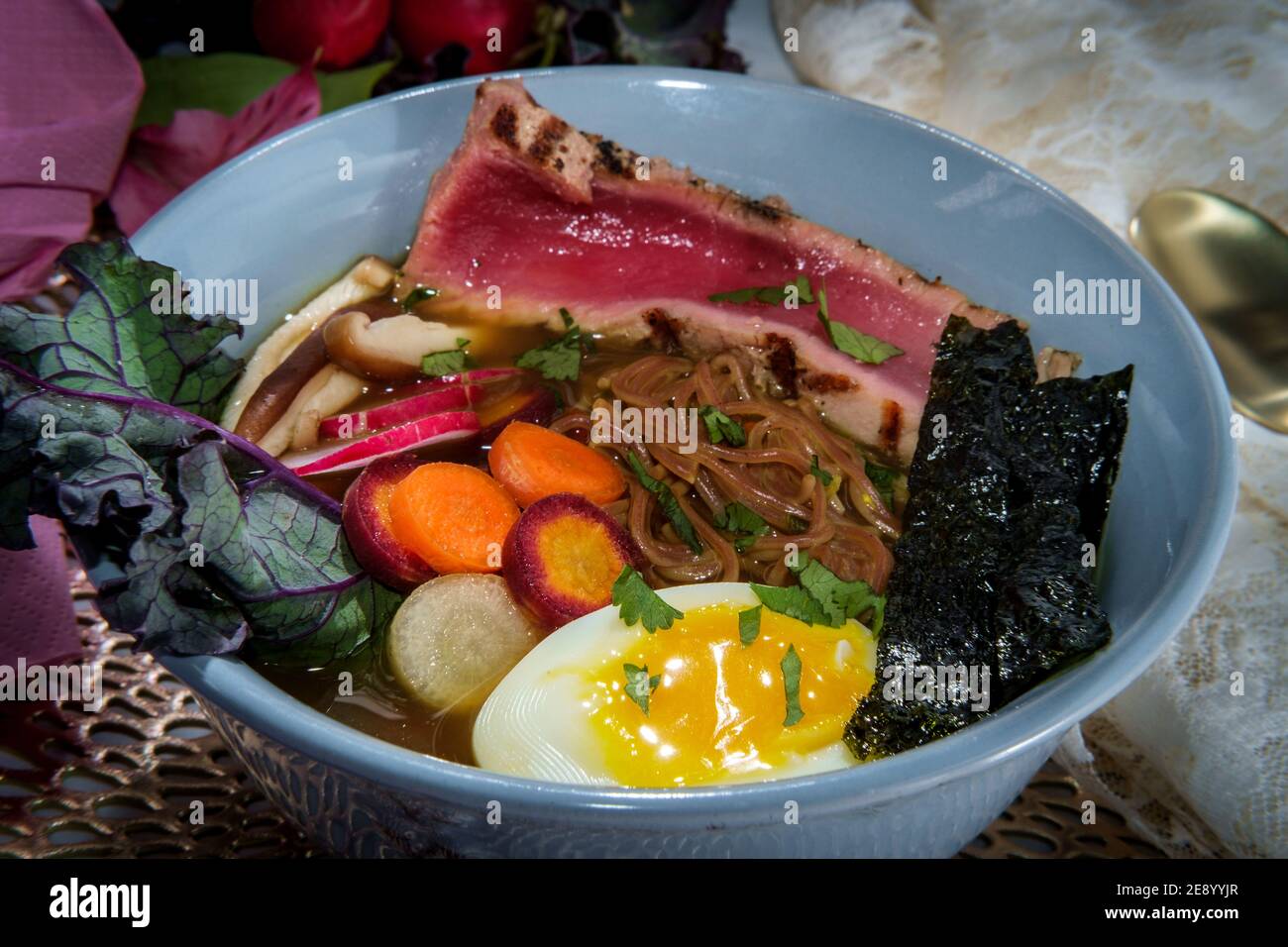 Seared pink ahi tuna ramen garnished with soft boiled egg seaweed ...