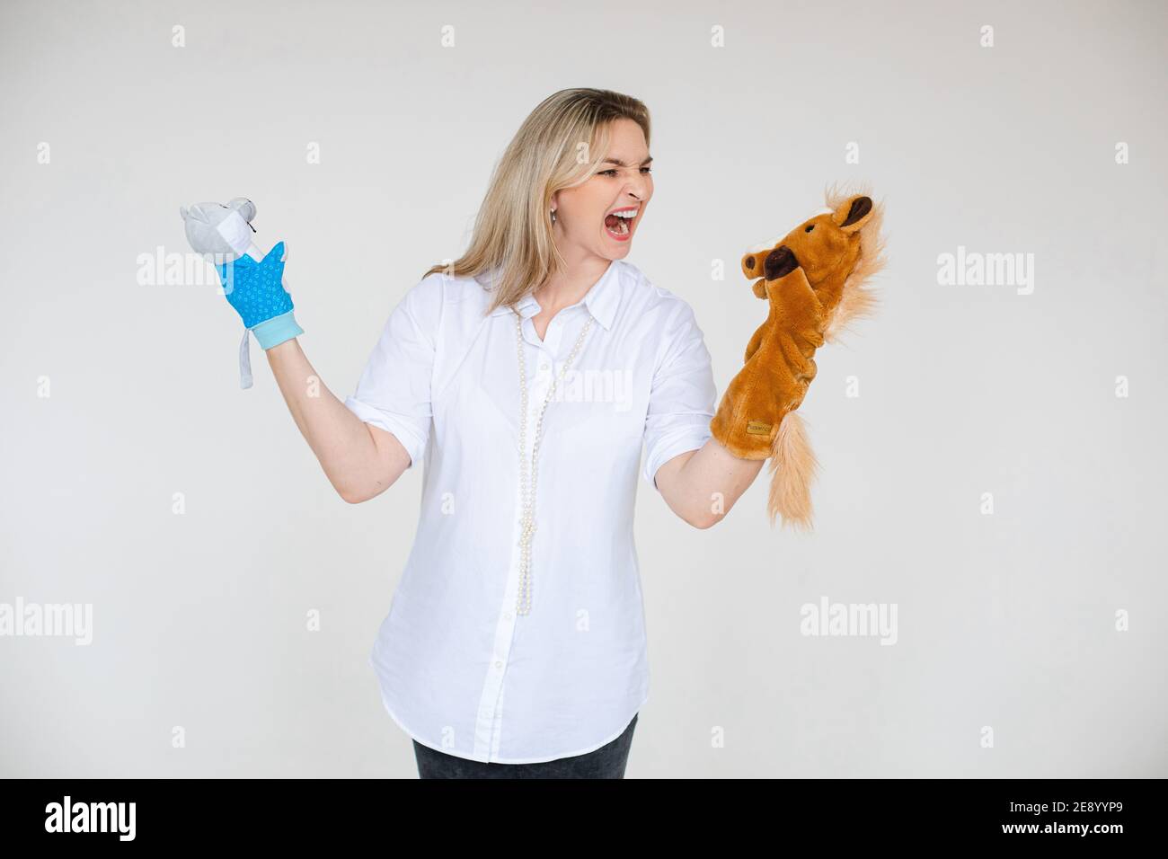 Angry girl shouting at puppet toy with pearl beads shouting at puppet ...