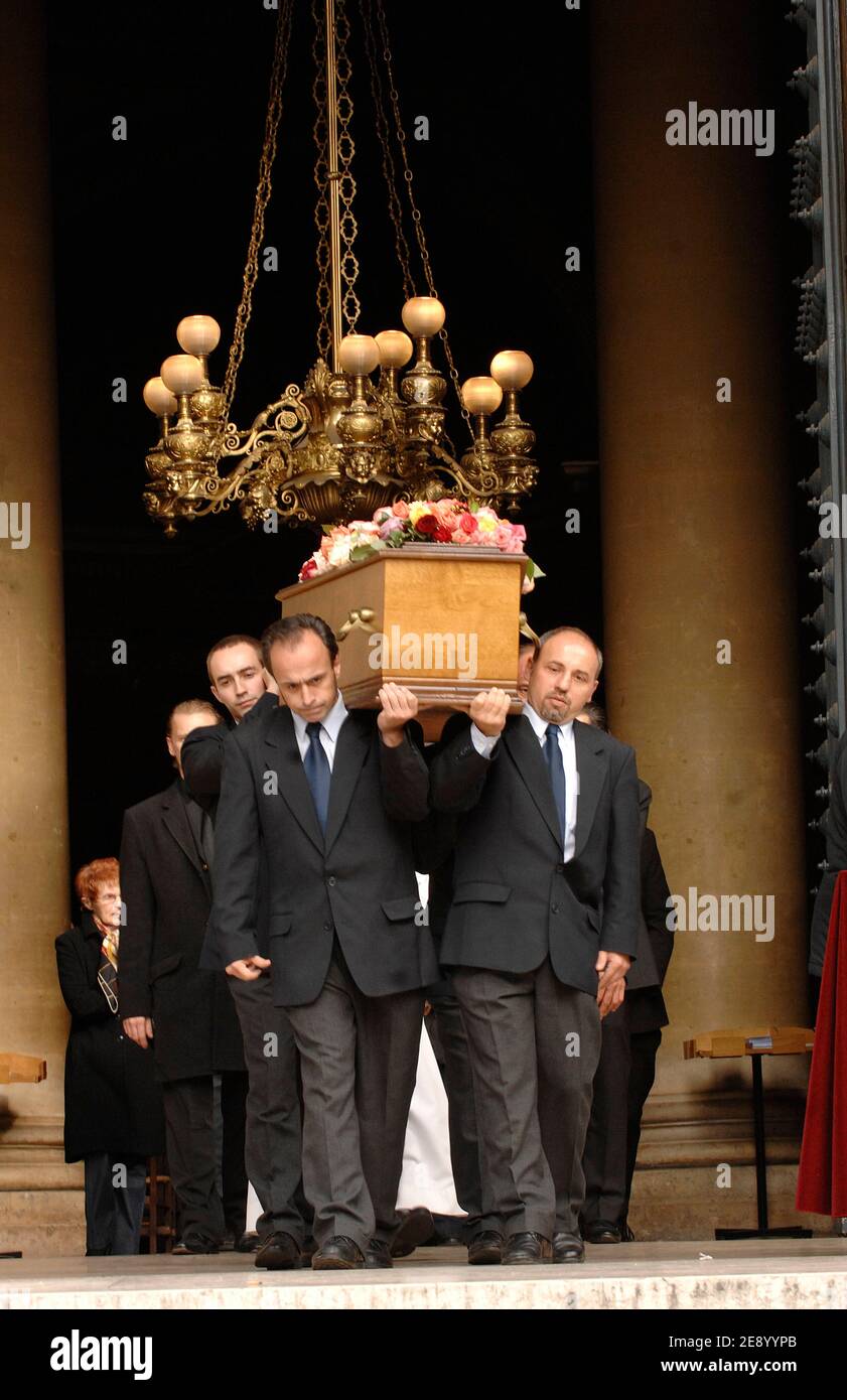 The coffin of photographer Luc Fournol is carried from Notre Dame de ...