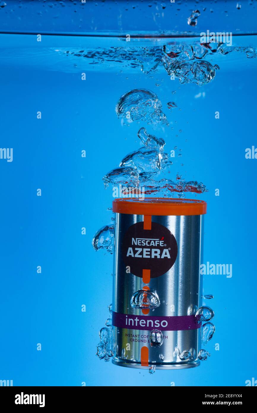 Freeze motion photo of a tin of Nescafe Azera coffee dropped into water ...