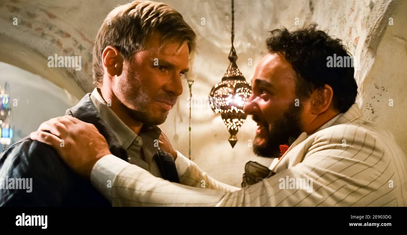 USA. John Rhys-Davies and Harrison Ford in a scene from the (C ...
