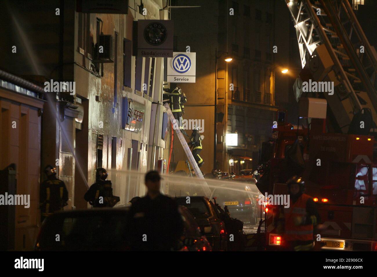Firefighters work on a scene of a fire caused by a car garage explosion ...