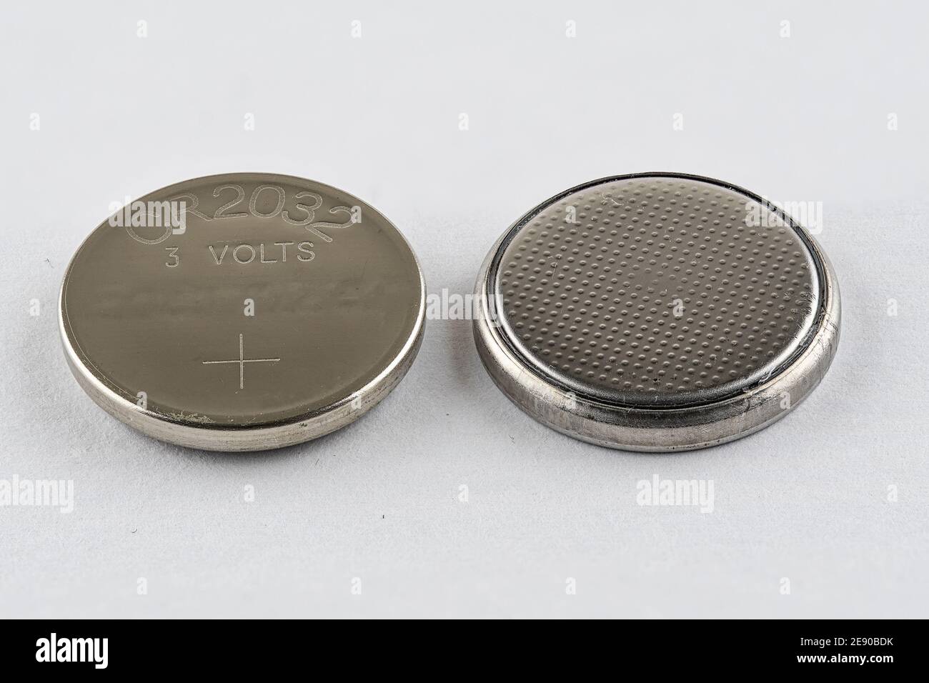 A CR2032 button cell lithium battery isolated Stock Photo - Alamy