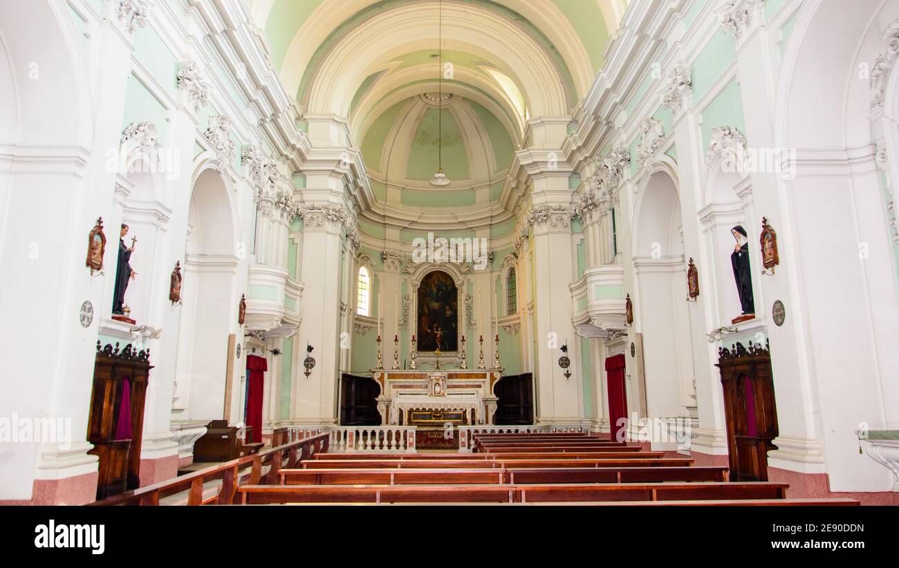 Amazing shot of a church interior with a white altar and holy sculpt ...