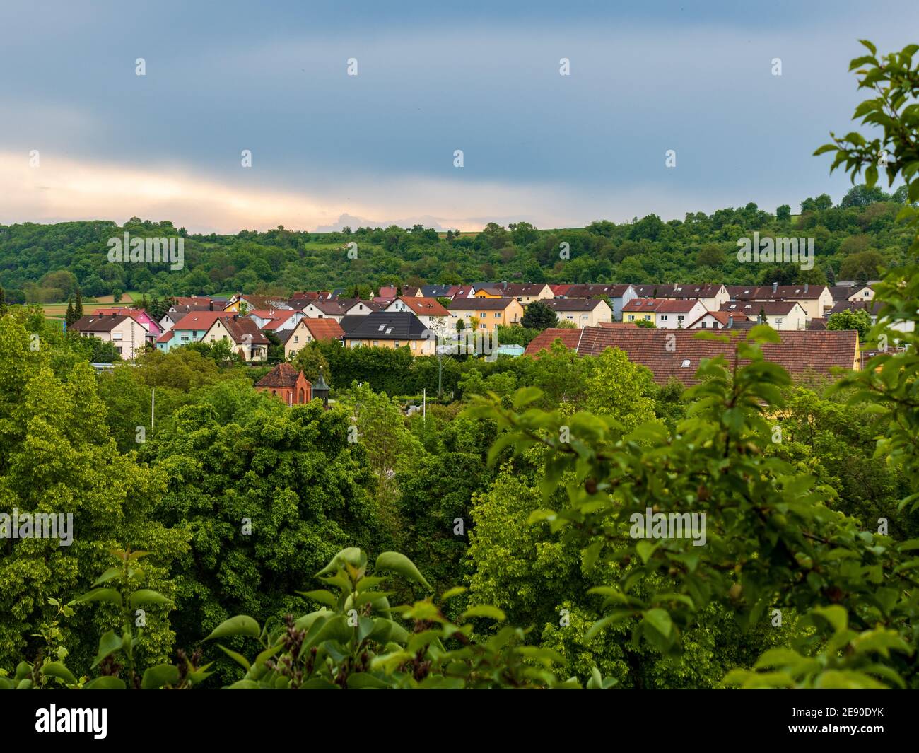 View over green landscape with houses and blue sky in small village ...