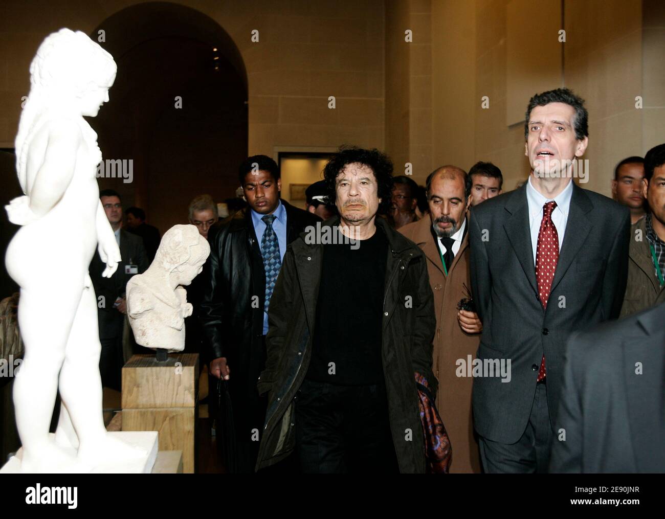 Libyan leader Moammar Gadhafi looks at statues as he visits the Louvre ...