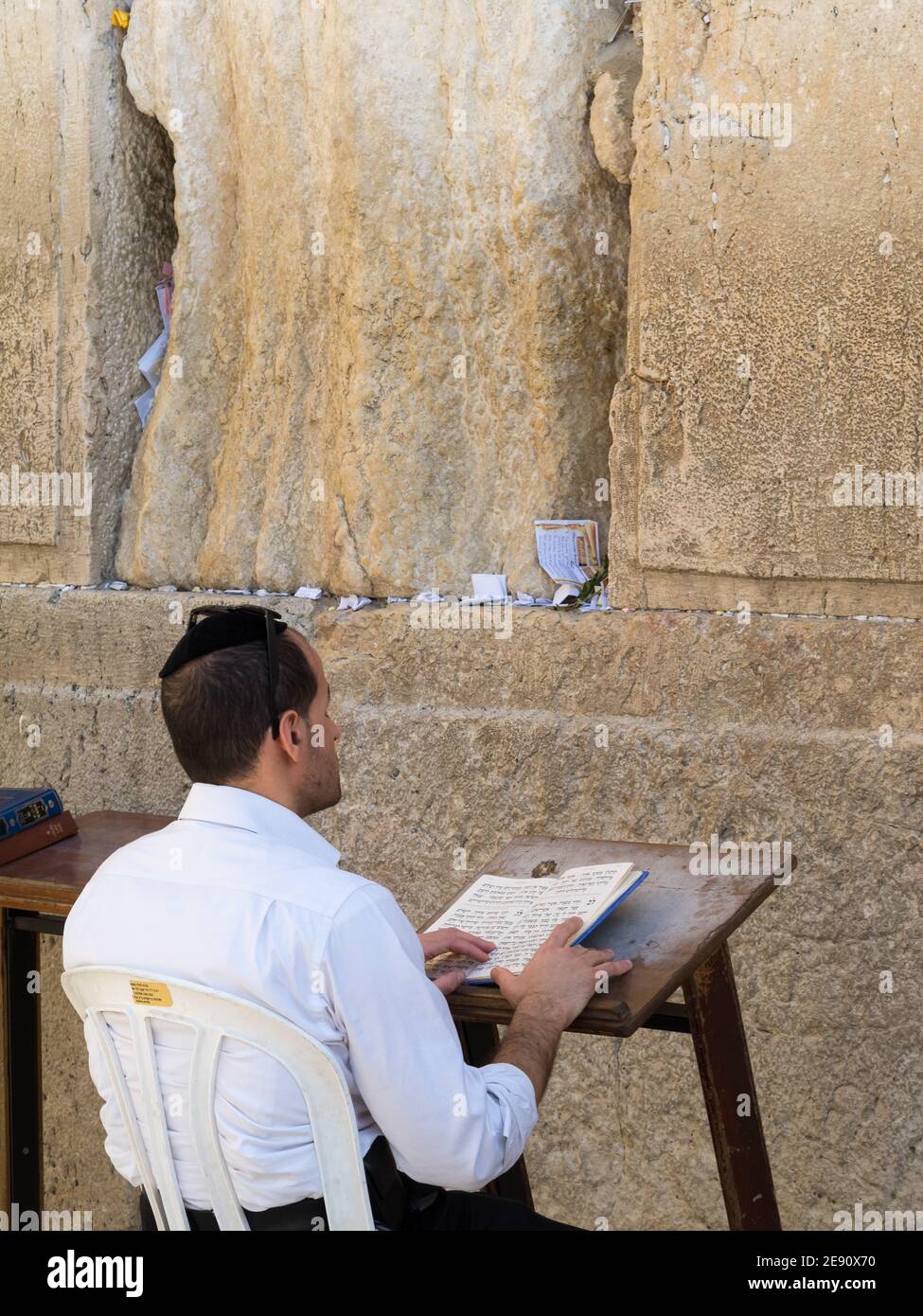 Jewish man reading the Torah by the Western Wall Stock Photo - Alamy
