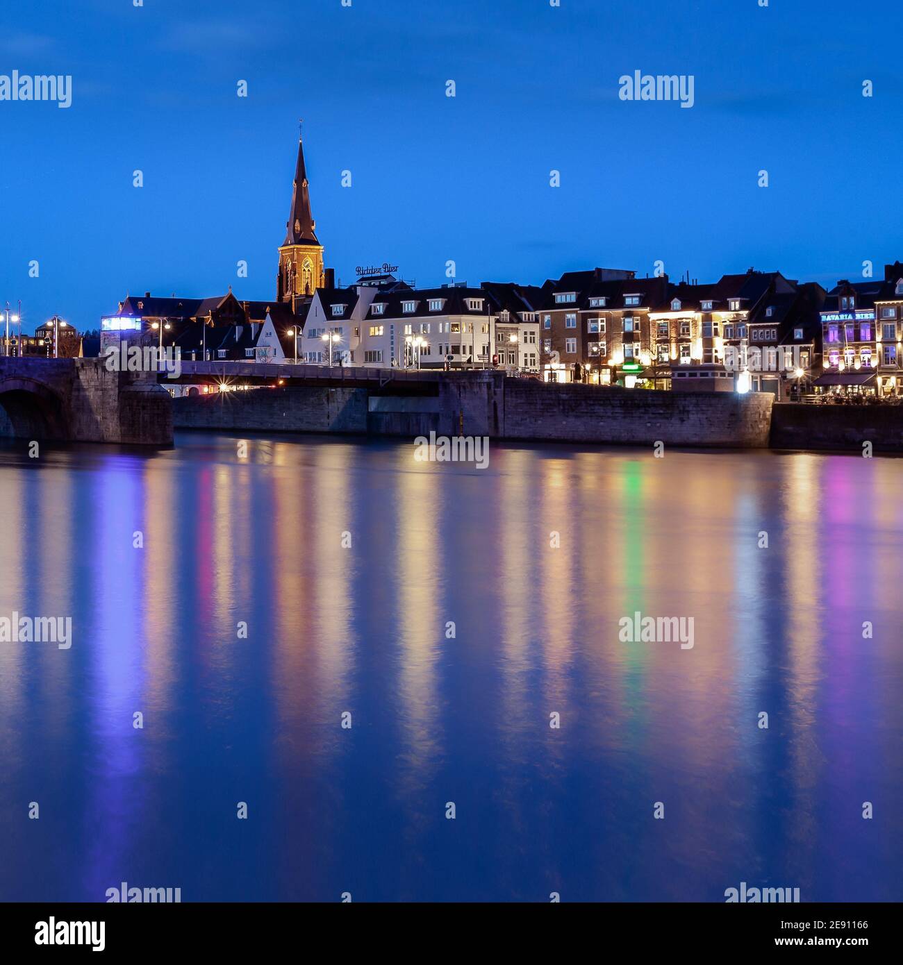 Aerial shot of a wonderful city with white buildings by the river with ...