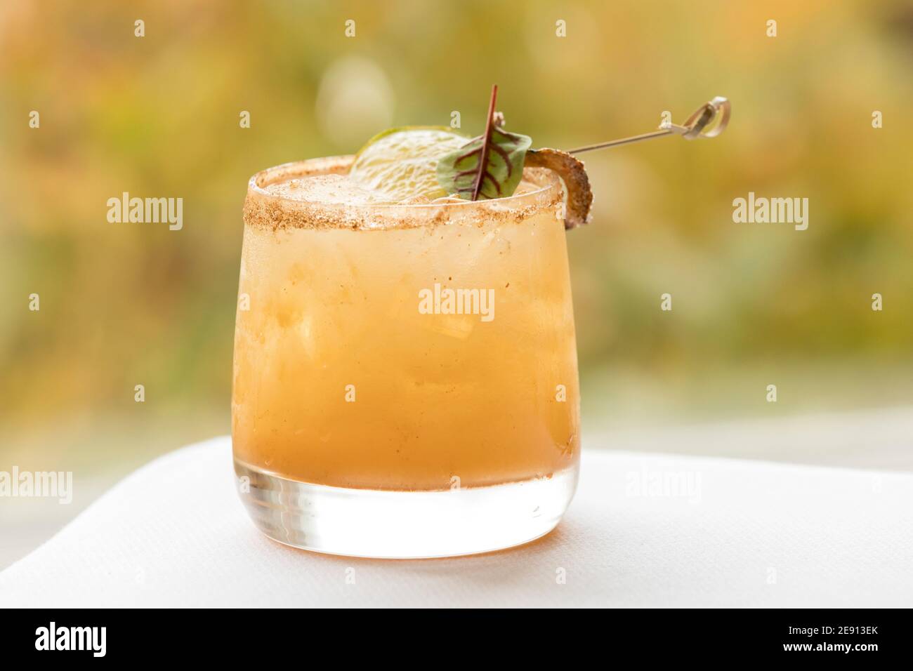 Colorful pumpkin fall-inspired cocktail with fall colors in background ...