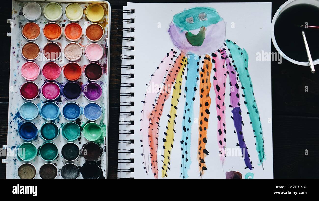 Child's watercolor artwork of a rainbow octopus smiling with colorful ...