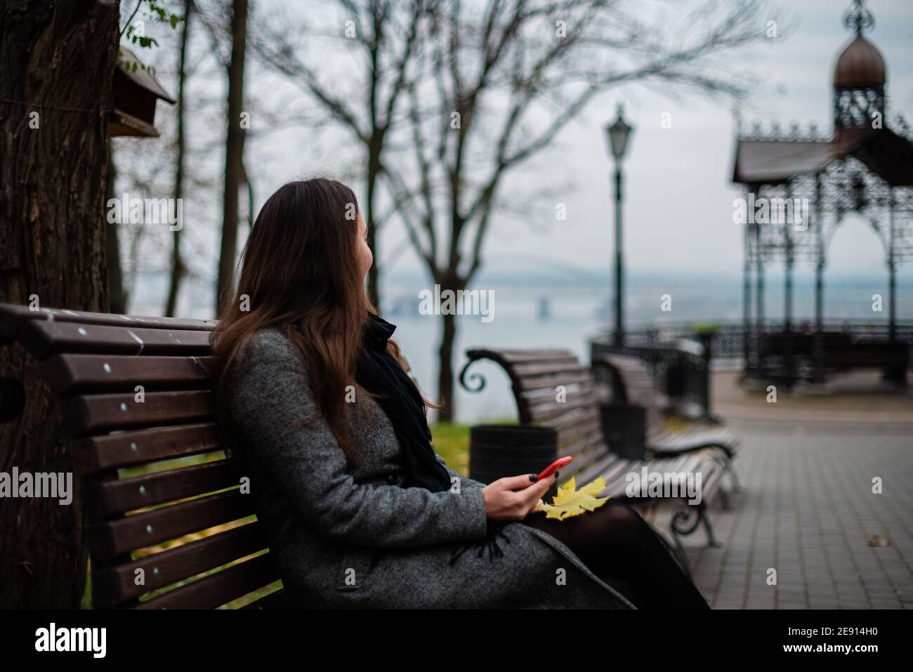 young woman sitting on the bench chilling and phone distraction Stock ...