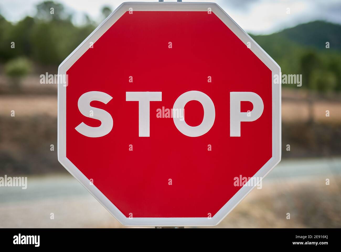 detail of an octoagonal stop sign with red background against a blue ...