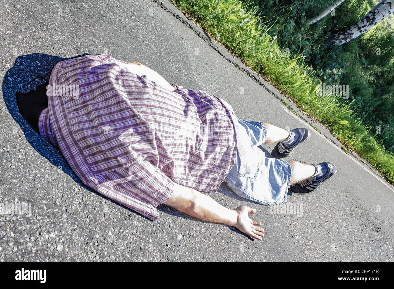Man is stuck with his head in the street. Put your head in the sand ...