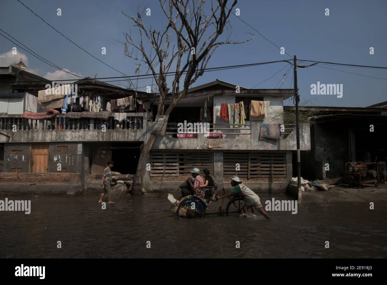 Sea water flooding the coastal area of Jakarta in Penjaringan district ...