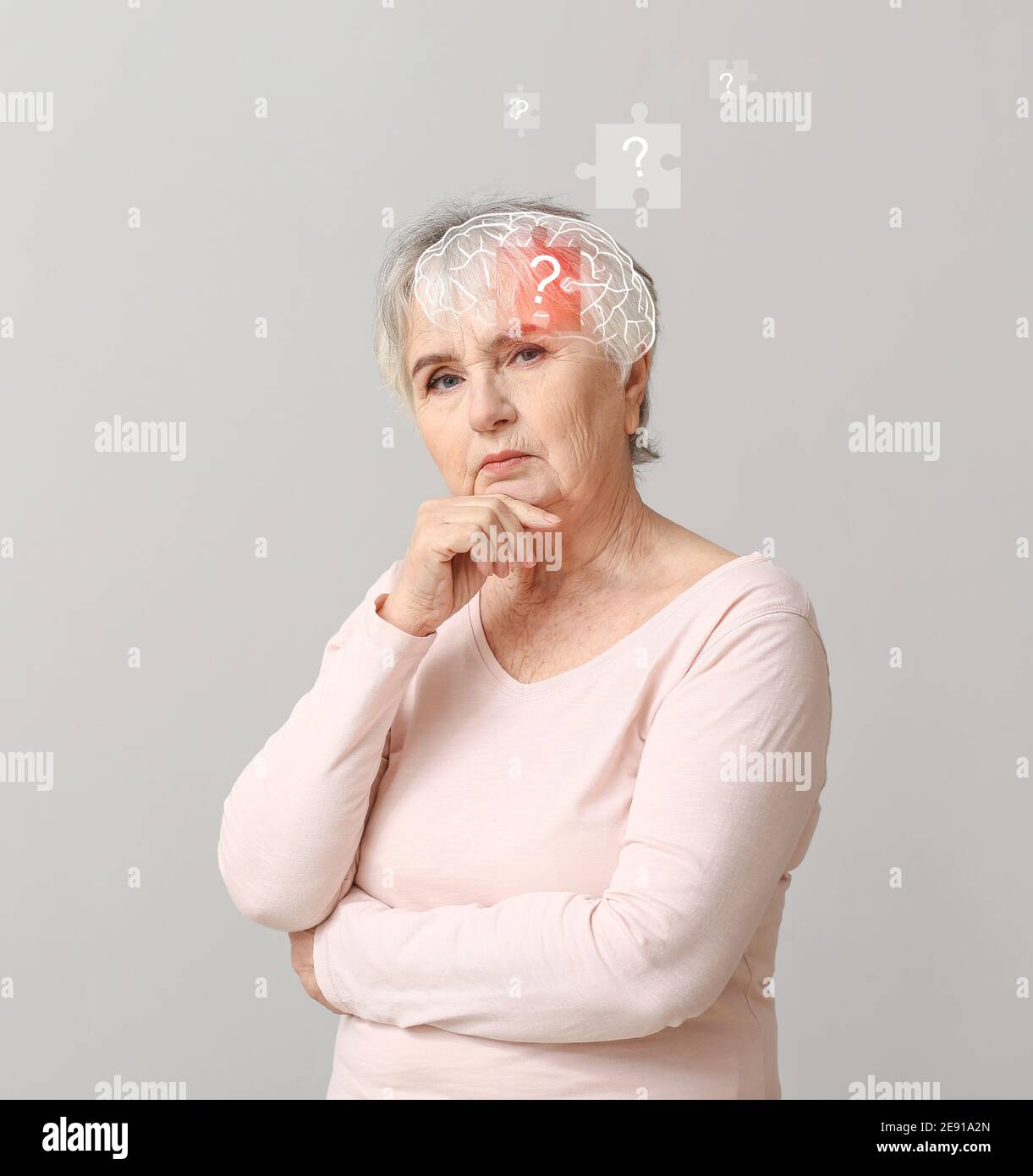 Elderly woman suffering from mental disability on grey background Stock ...