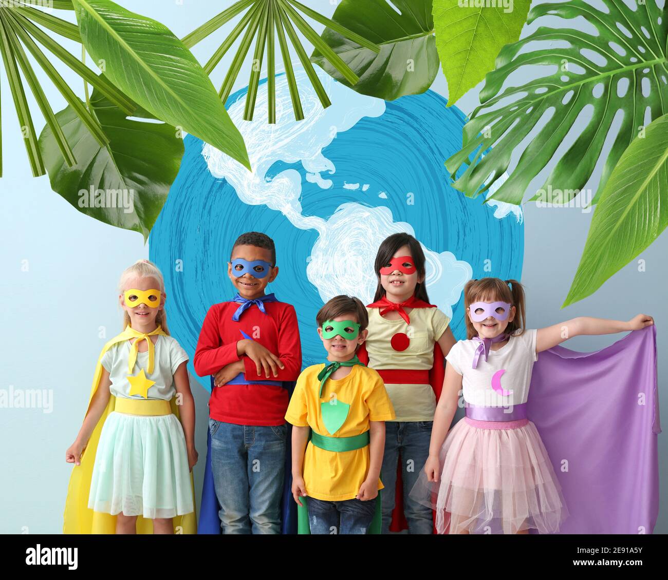 Cute little children dressed as superheroes near drawing of planet on ...