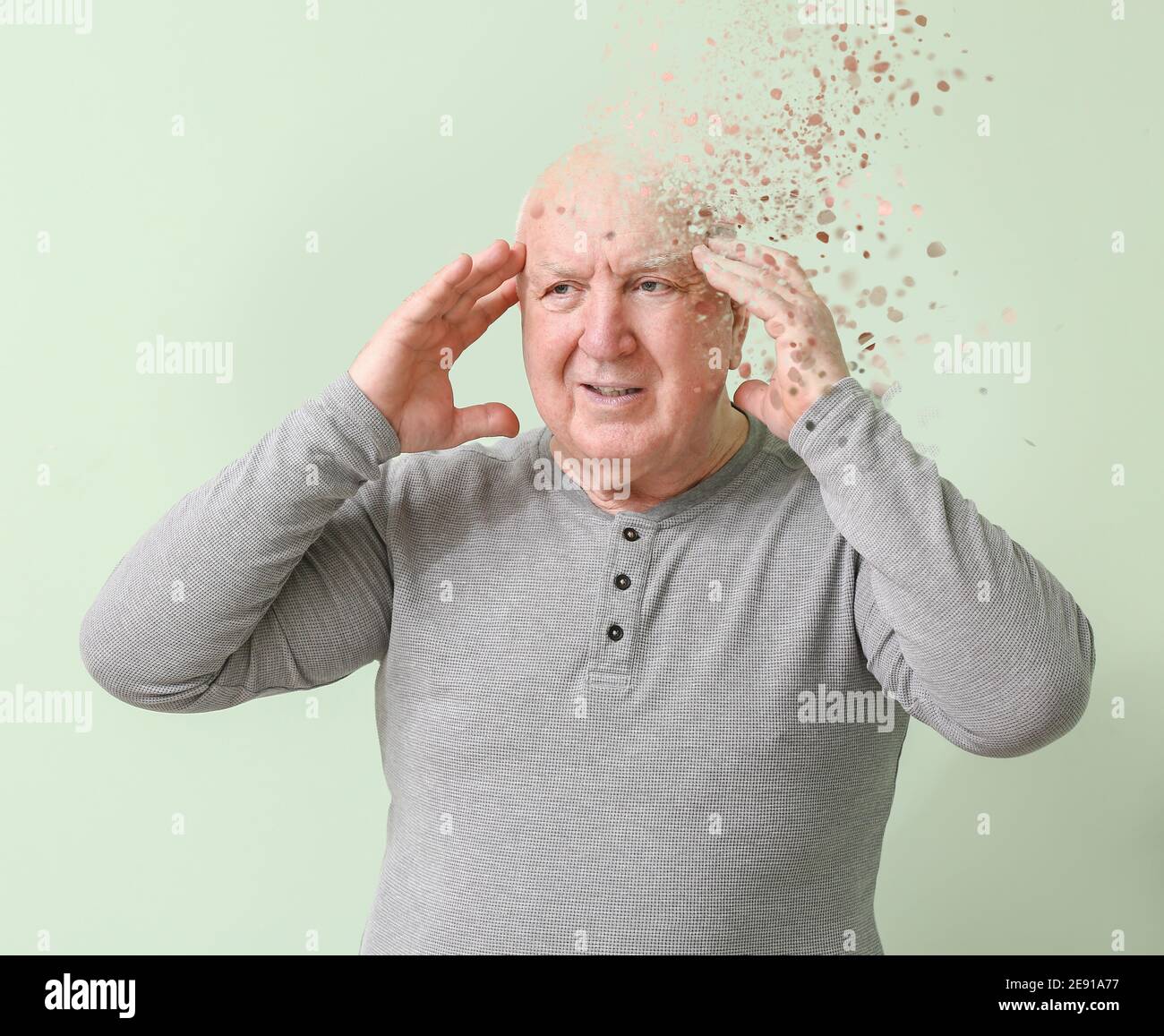 Elderly man suffering from mental disability on color background Stock ...