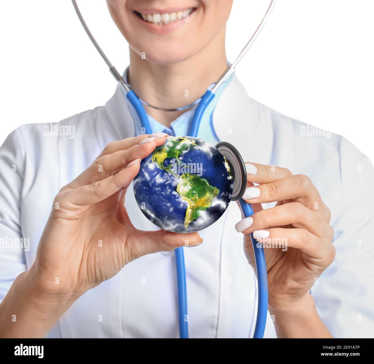 Female doctor with stethoscope and model of Earth on white background ...