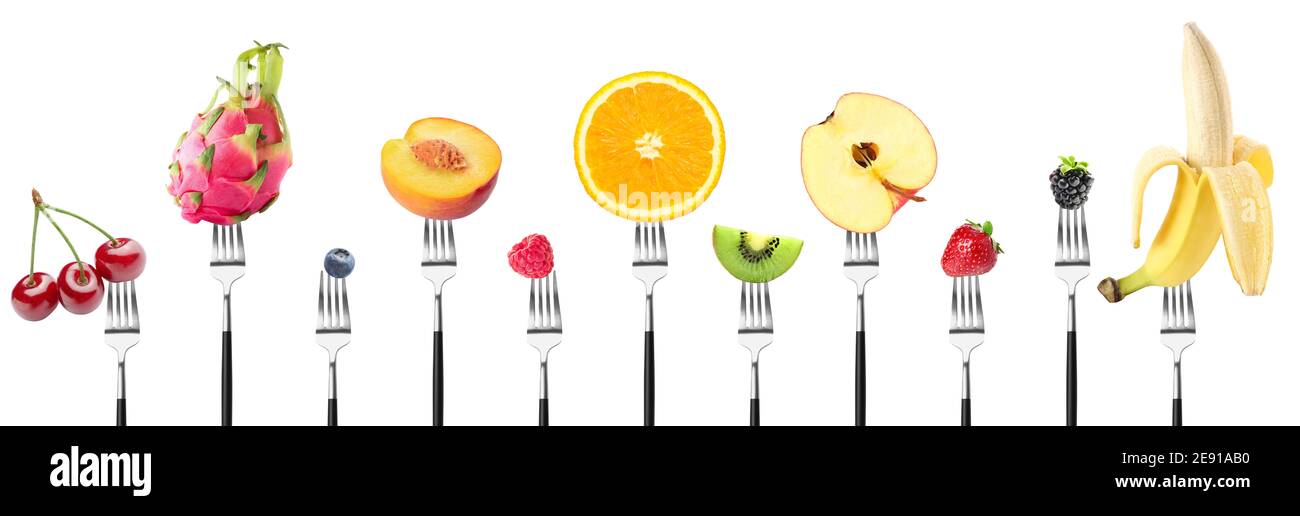 Different fruits impaled on forks against white background Stock Photo ...