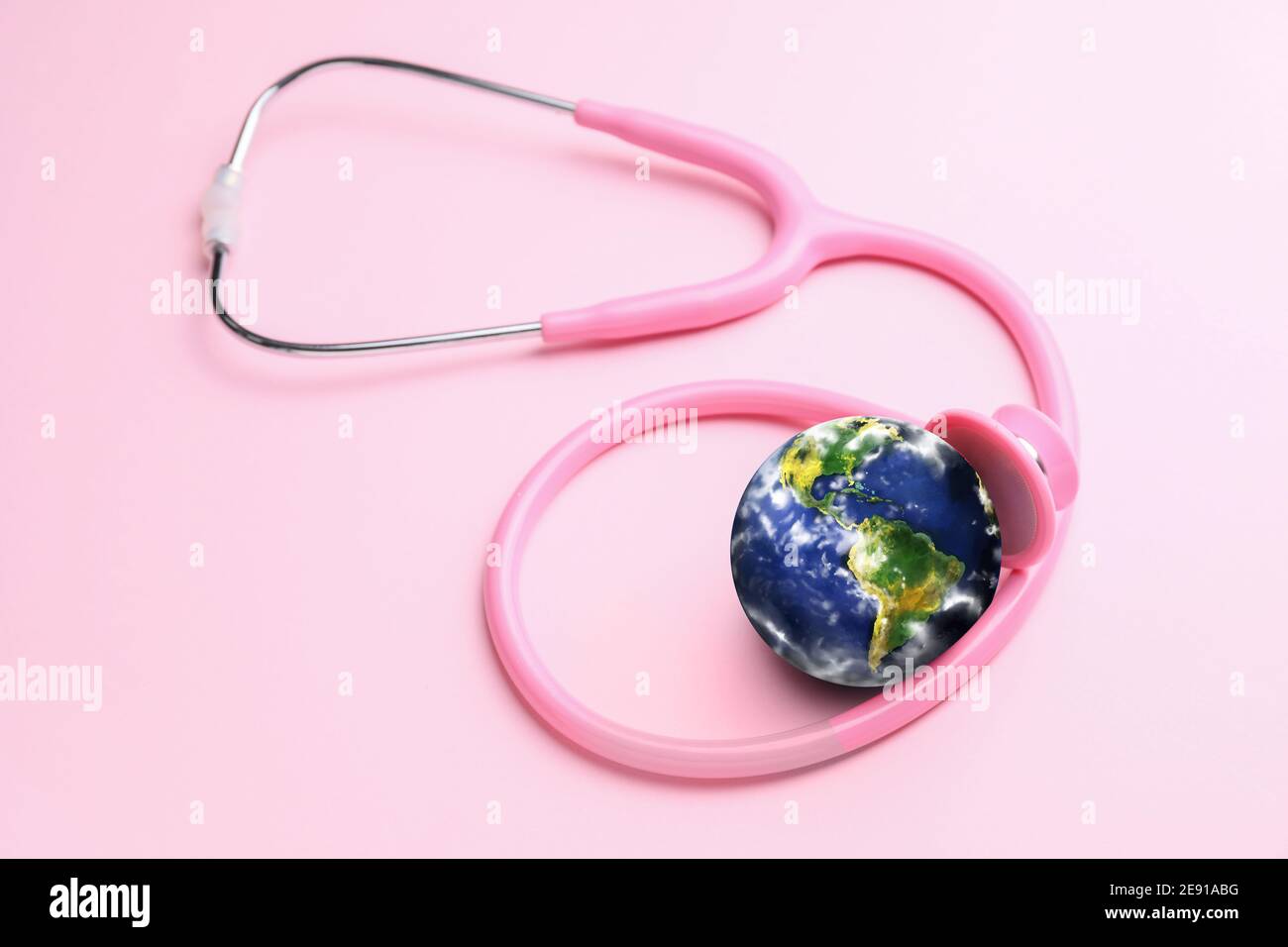 Stethoscope and model of Earth on color background. Ecology concept ...