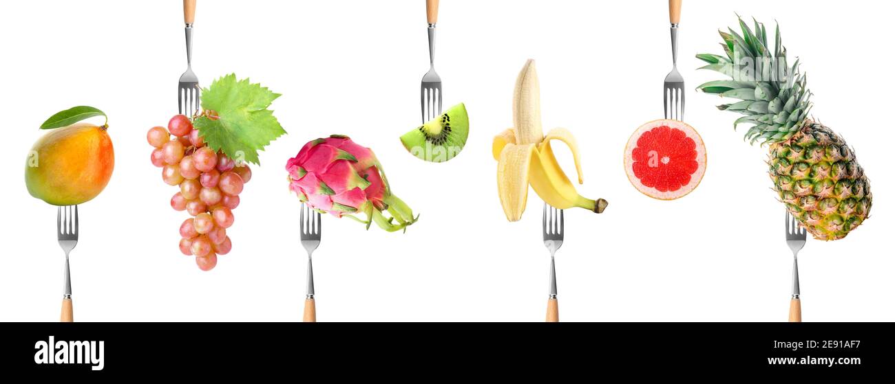 Different fruits impaled on forks against white background Stock Photo ...