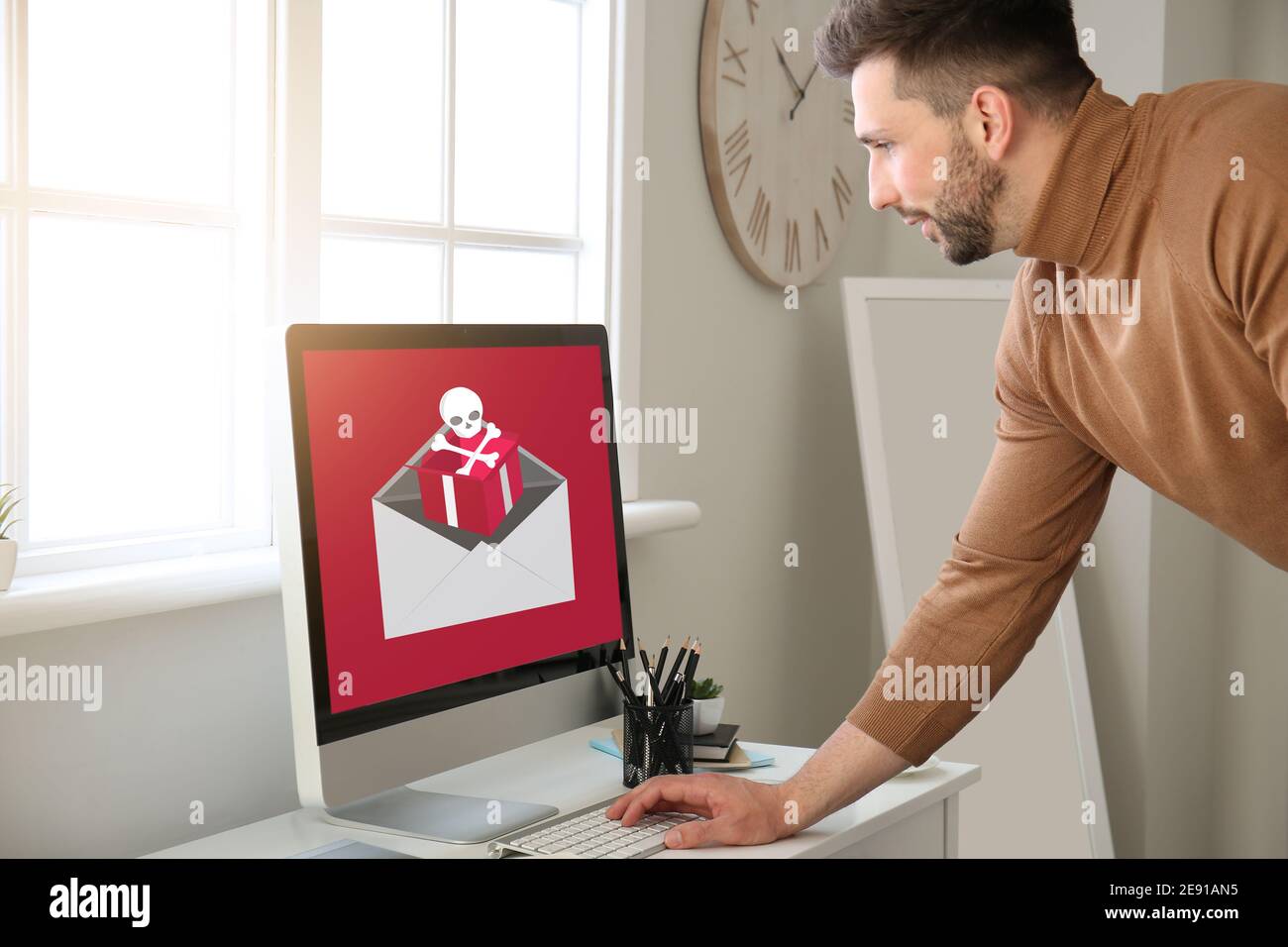 Young man with received infected email message on screen of computer at ...