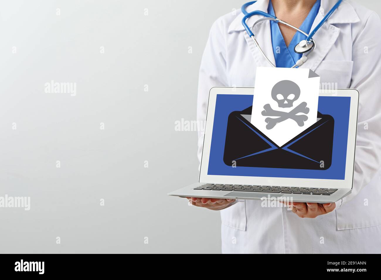Female doctor with received infected email message on screen of laptop ...