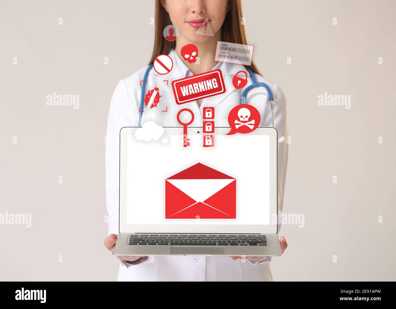 Female doctor with received infected email message on screen of laptop ...