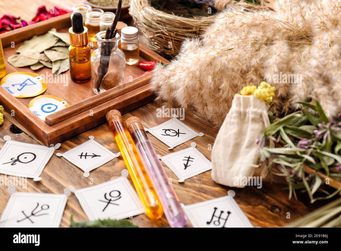 Alchemical symbols and ingredients for preparing potions on wooden ...