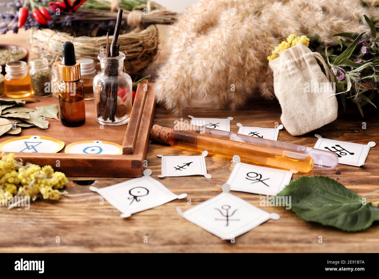 Alchemical symbols and ingredients for preparing potions on wooden ...