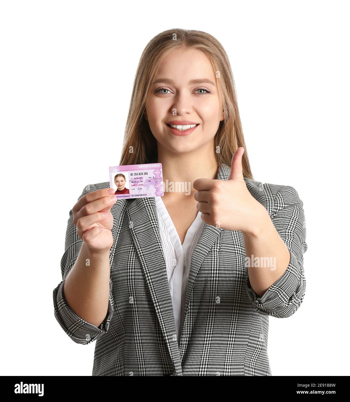 Happy young businesswoman with driving license on white background ...